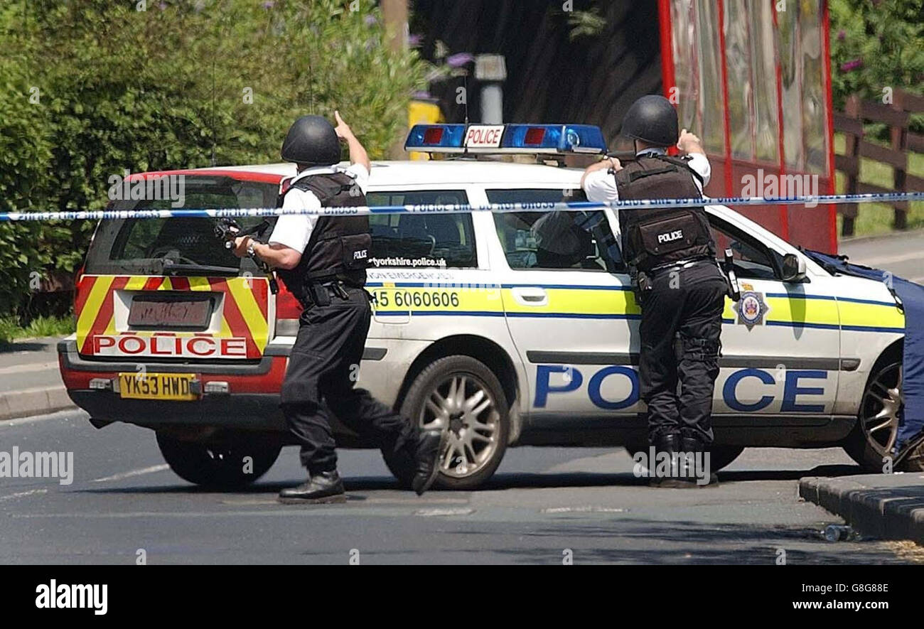 Armed police took up positions outside a house in Leeds today during a ...
