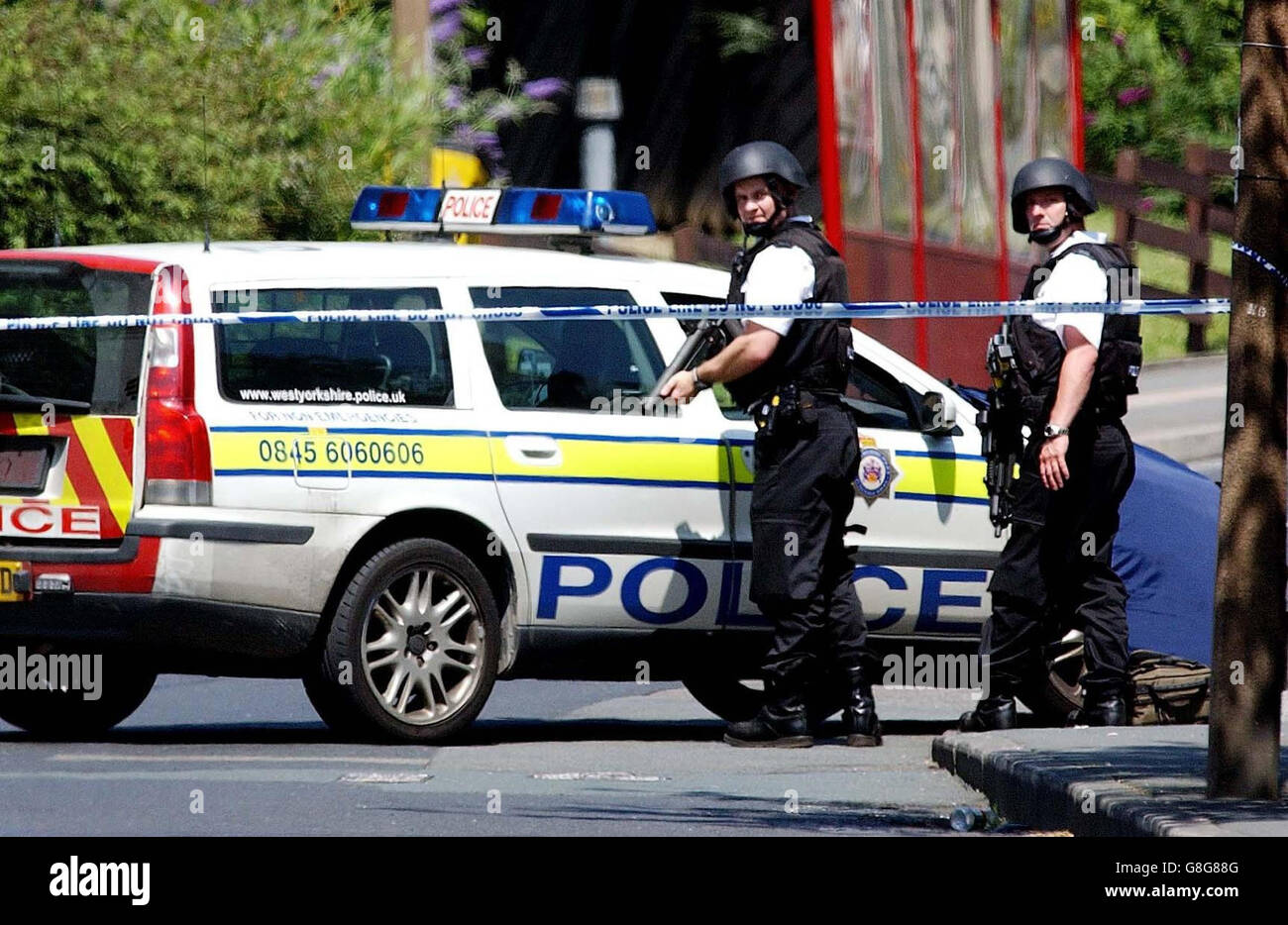 Armed police took up positions outside a house in Leeds today during a ...