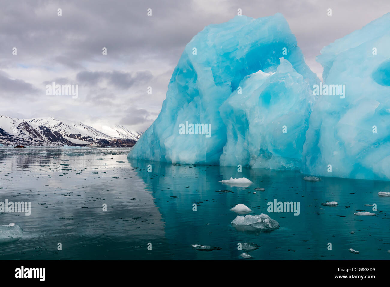 Deep blue iceberg in Liefdefjord, Svalbard Archipelago, Norway. These ...