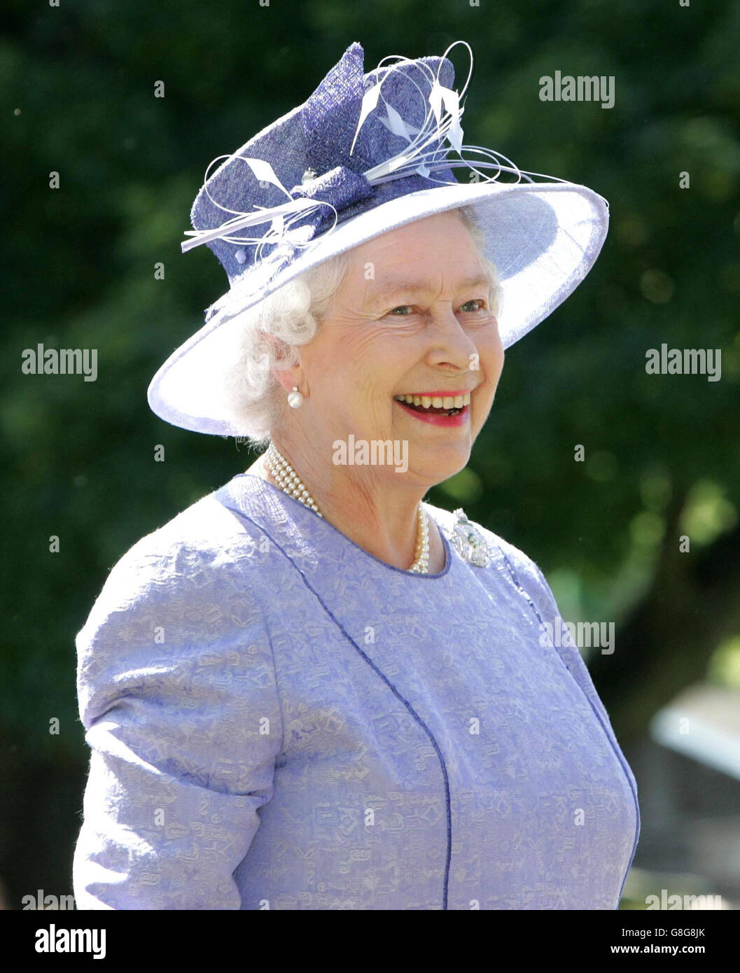 Britain's Queen Elizabeth II smiles while inspecting uniforms of one of ...