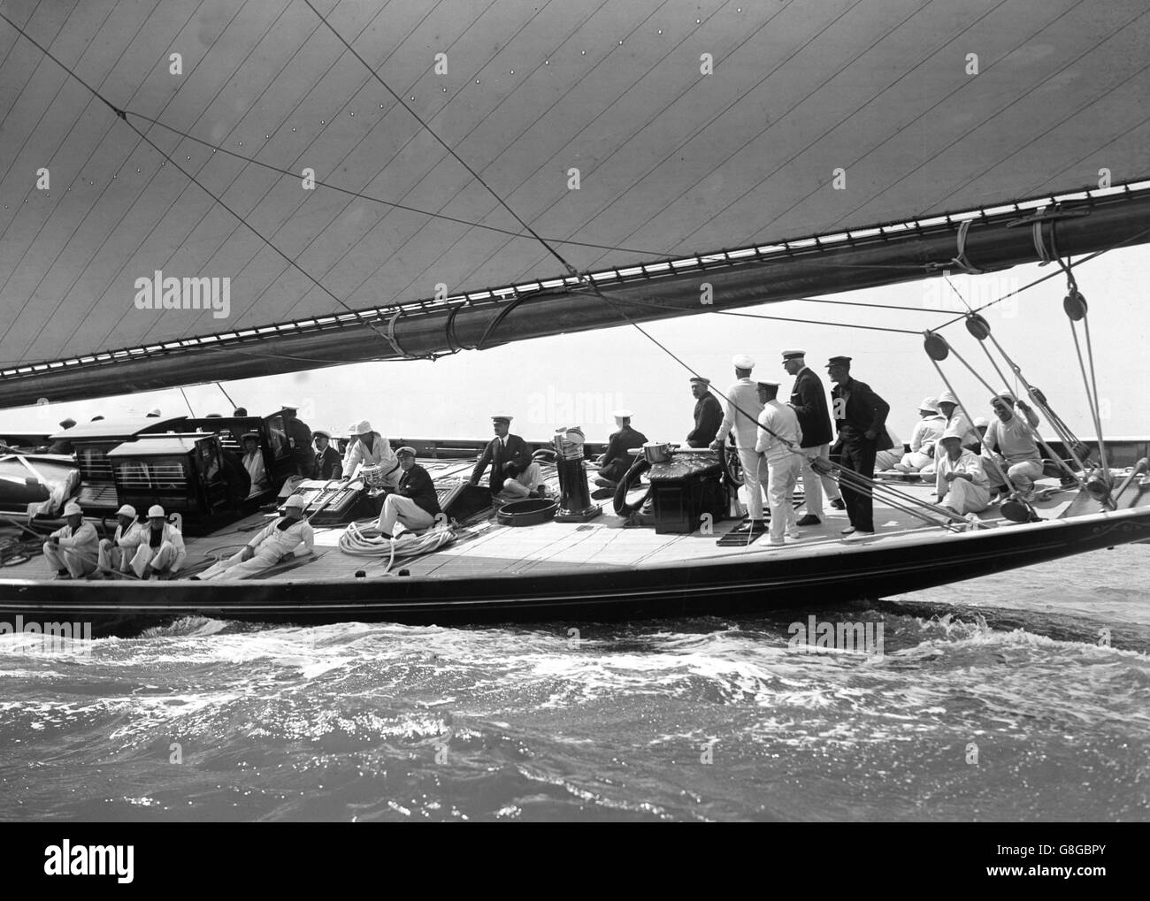 King George V on board his yacht at Cowes. At the wheel is Major ...