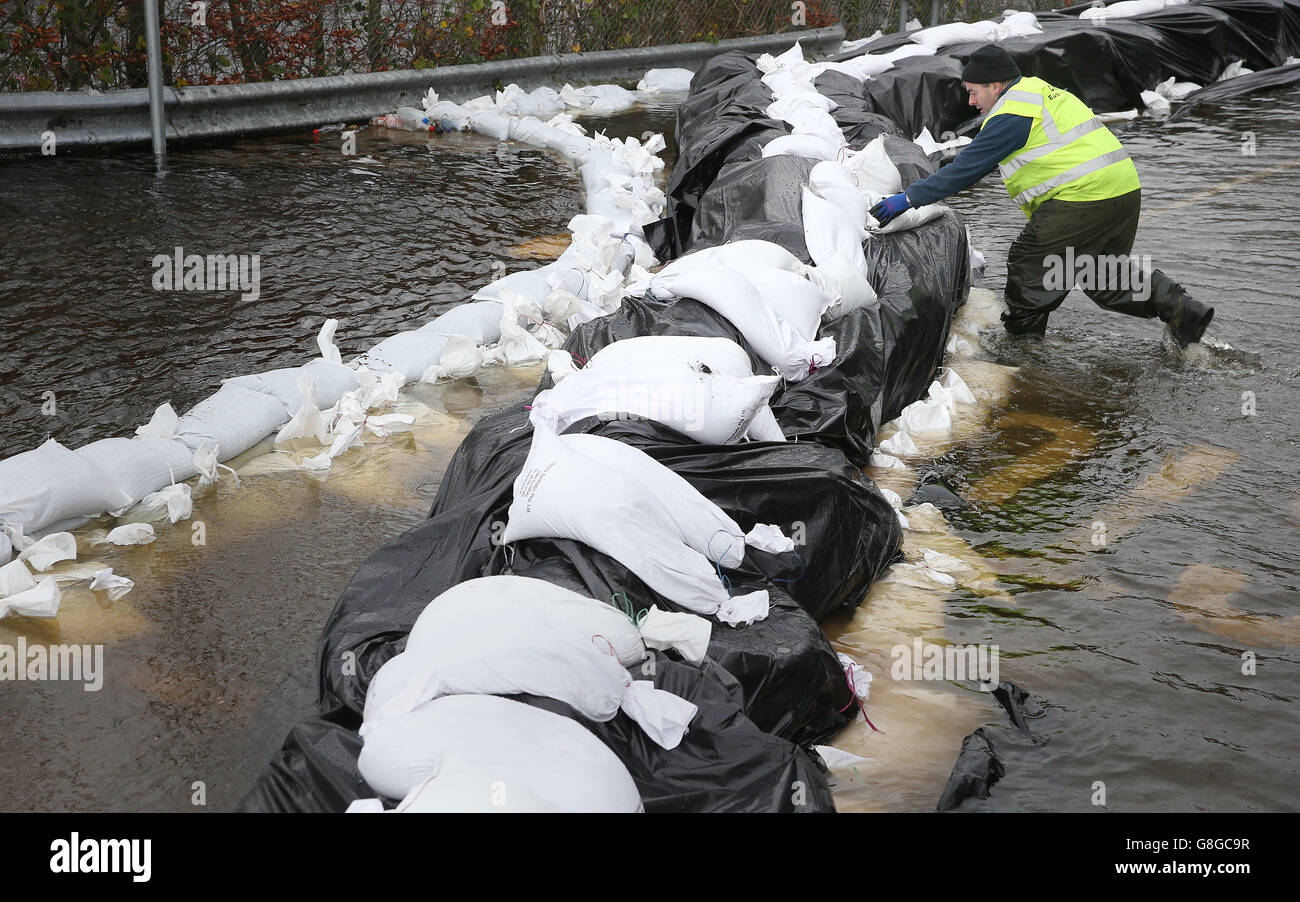 Local Councillor Kevin Moran helps with flood defences in the town ...
