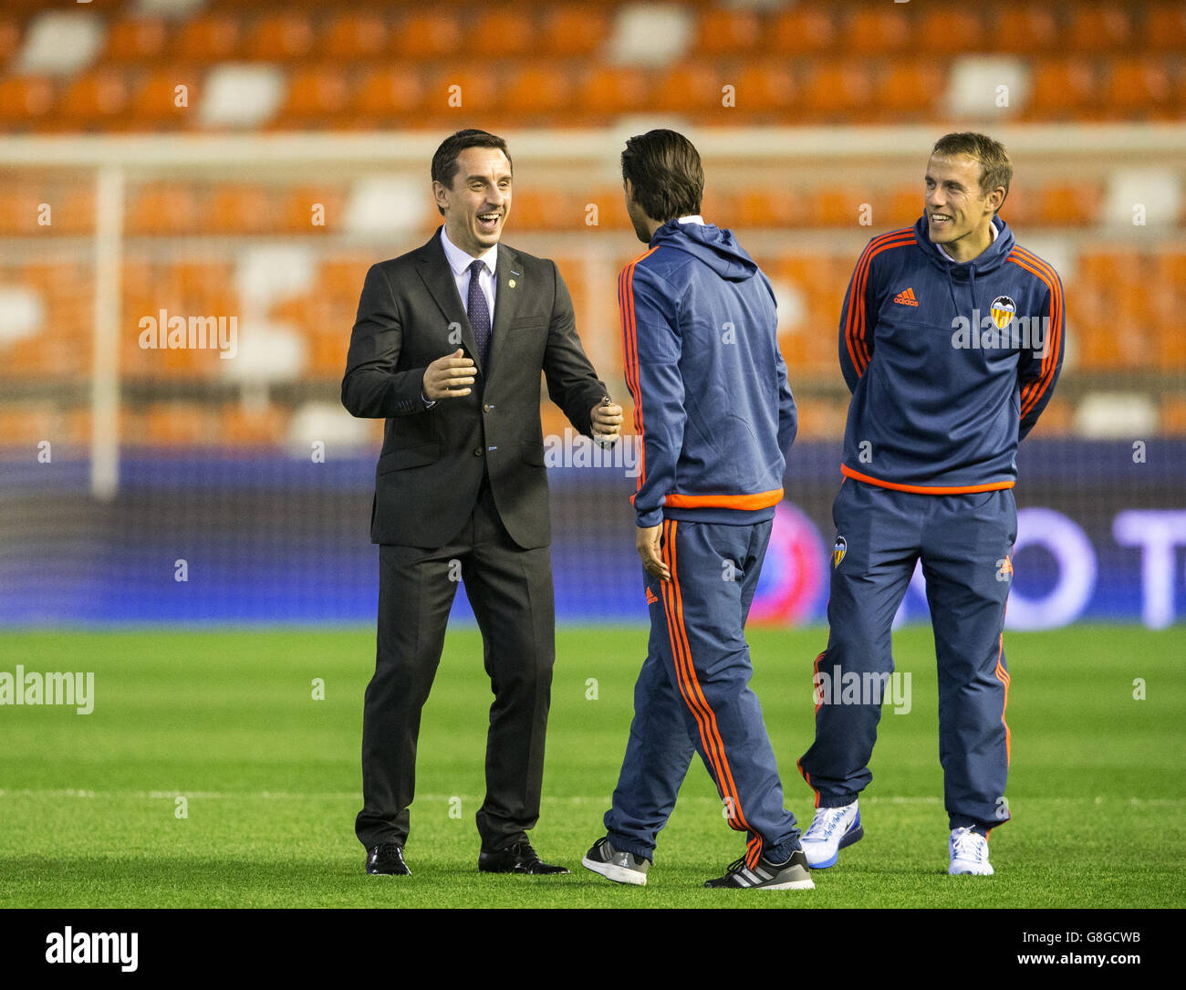 Valencia manager Gary Neville (left) speaks with his assistants ...