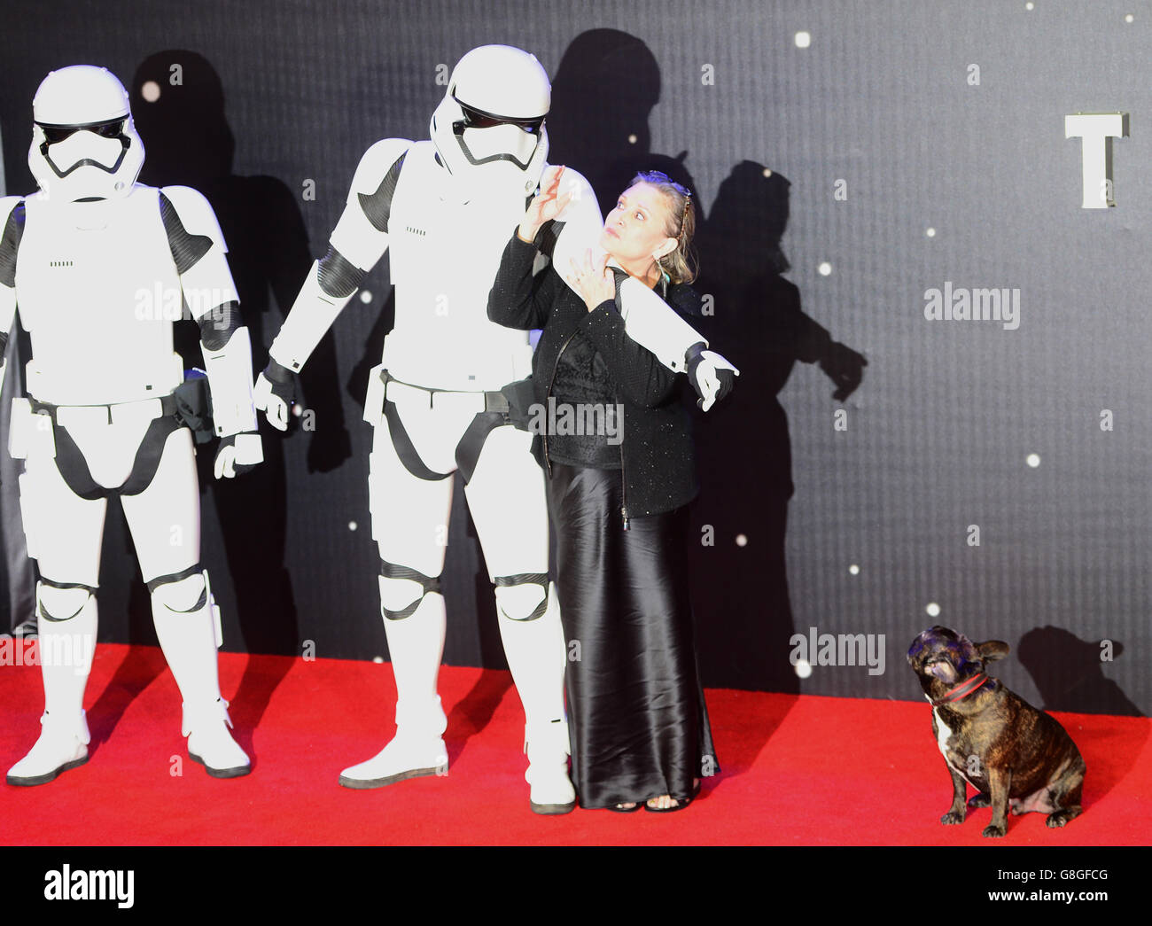 Carrie Fisher with a Stormtrooper and her dog Gary (right) as she ...