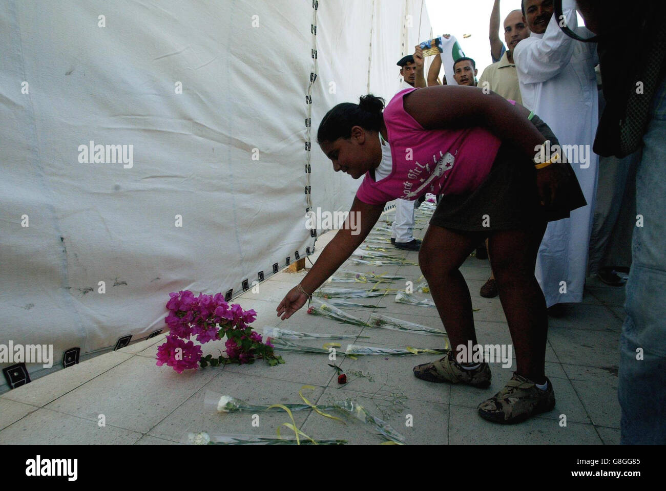 A young girl lays flowers outside the Ghazala Gardens Hotel in Sharm El ...