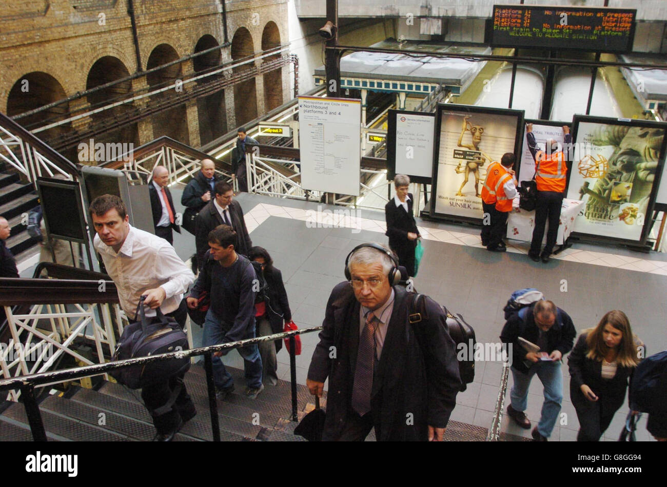Commuters get off an underground train at Aldgate Station. Today saw ...