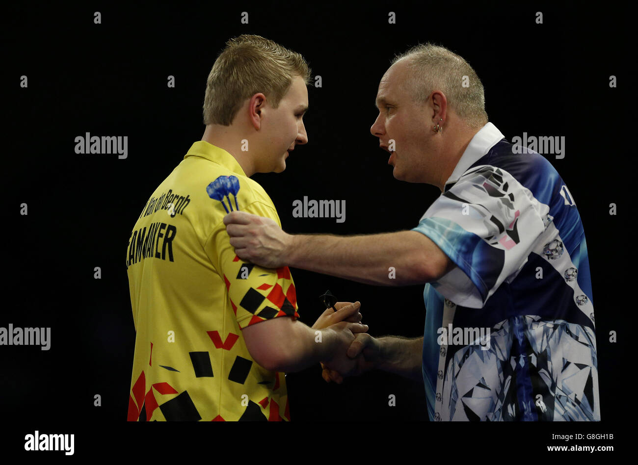 Dimitri Van den Bergh (left) shakes hands with Ian White after winning ...