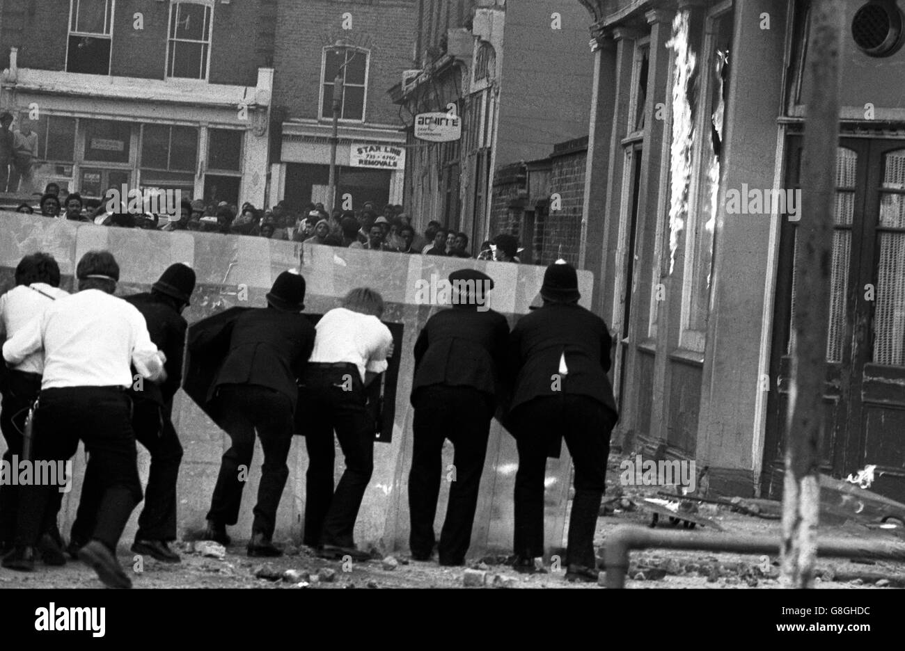 Police confront a group of youths from behind their riot shields in ...