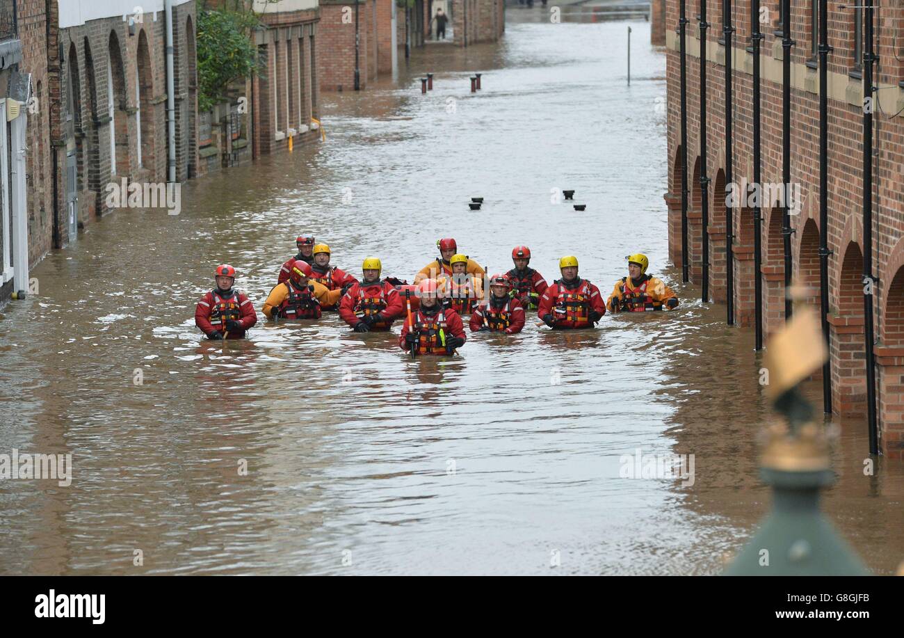 Members of the mountain rescue wade through floodwater in skeldergate ...