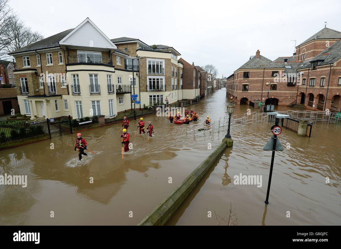 Members of the mountain rescue wade through floodwater in skeldergate ...
