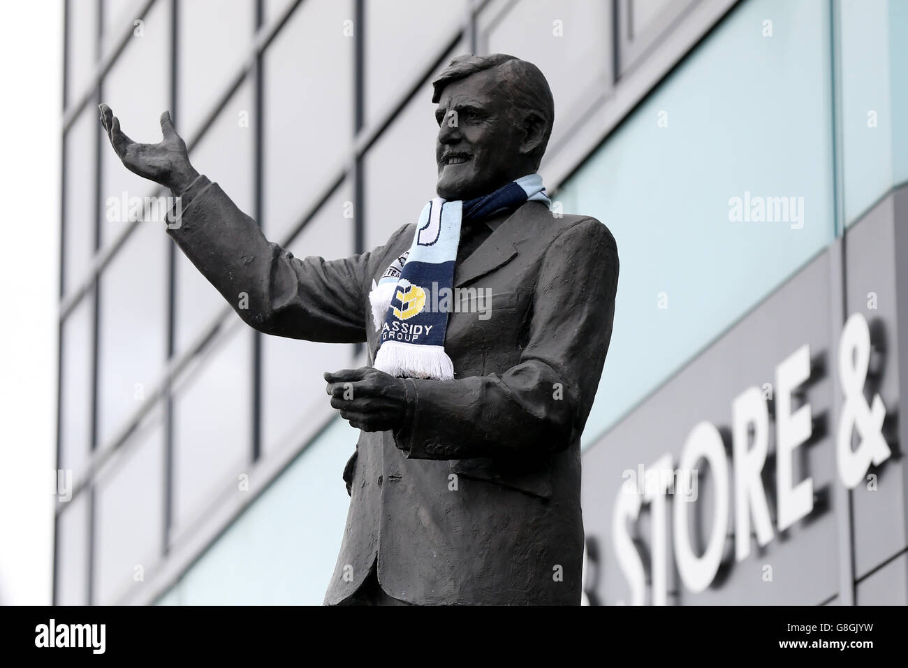 Floral tributes are left at the foot of the Jimmy Hill statue as people ...