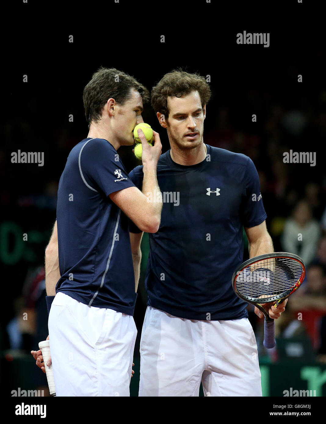 Great Britain's Jamie Murray (left) speaks with Andy Murray during day ...