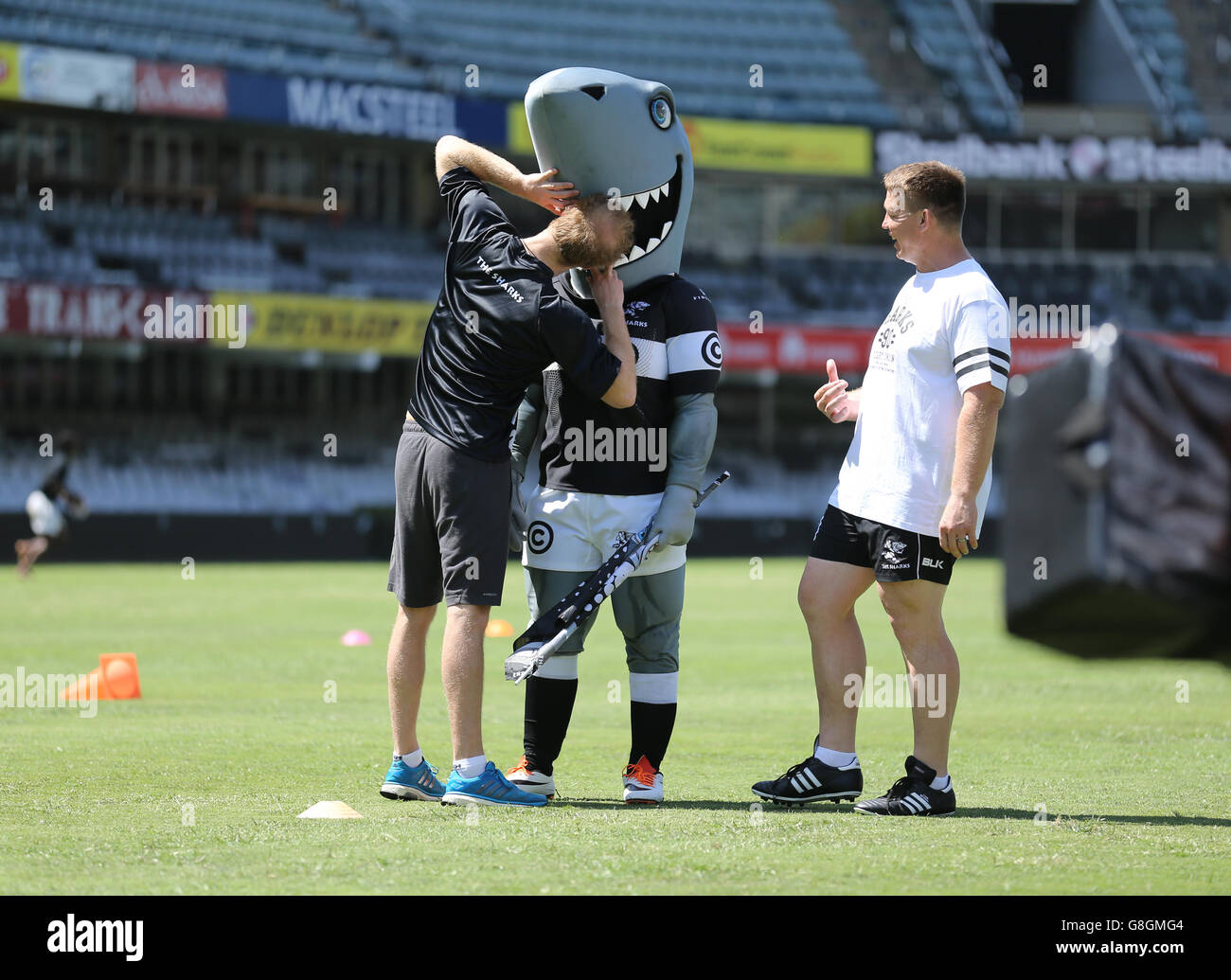 Prince Harry meets the mascot Sharkie as he walks onto the pitch at ...