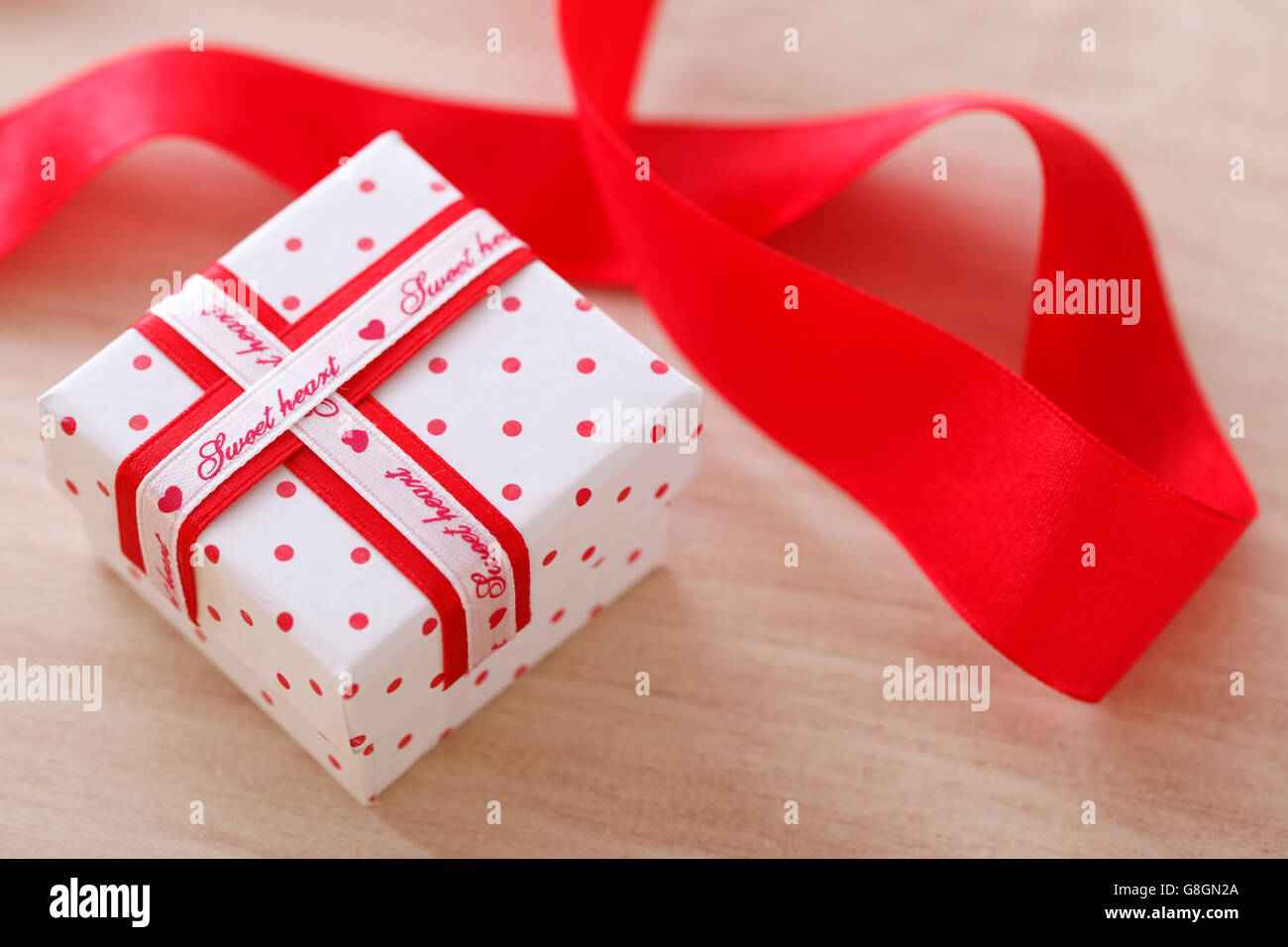 Valentine's day gift box with red ribbon Stock Photo - Alamy
