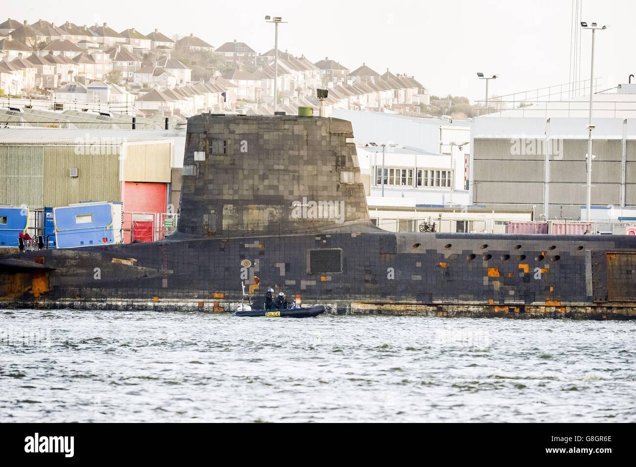 Police patrol around HMS Vanguard, one of the UK's nuclear deterrent V ...