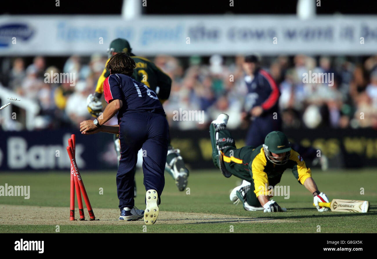 Middlesex's Melvyn Betts (L) runs out Leicestershire's Jeremy Snape ...