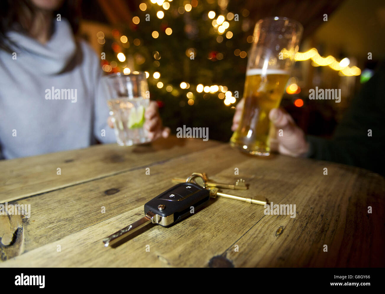 A couple drinking in a pub in north London, with car keys on the table ...