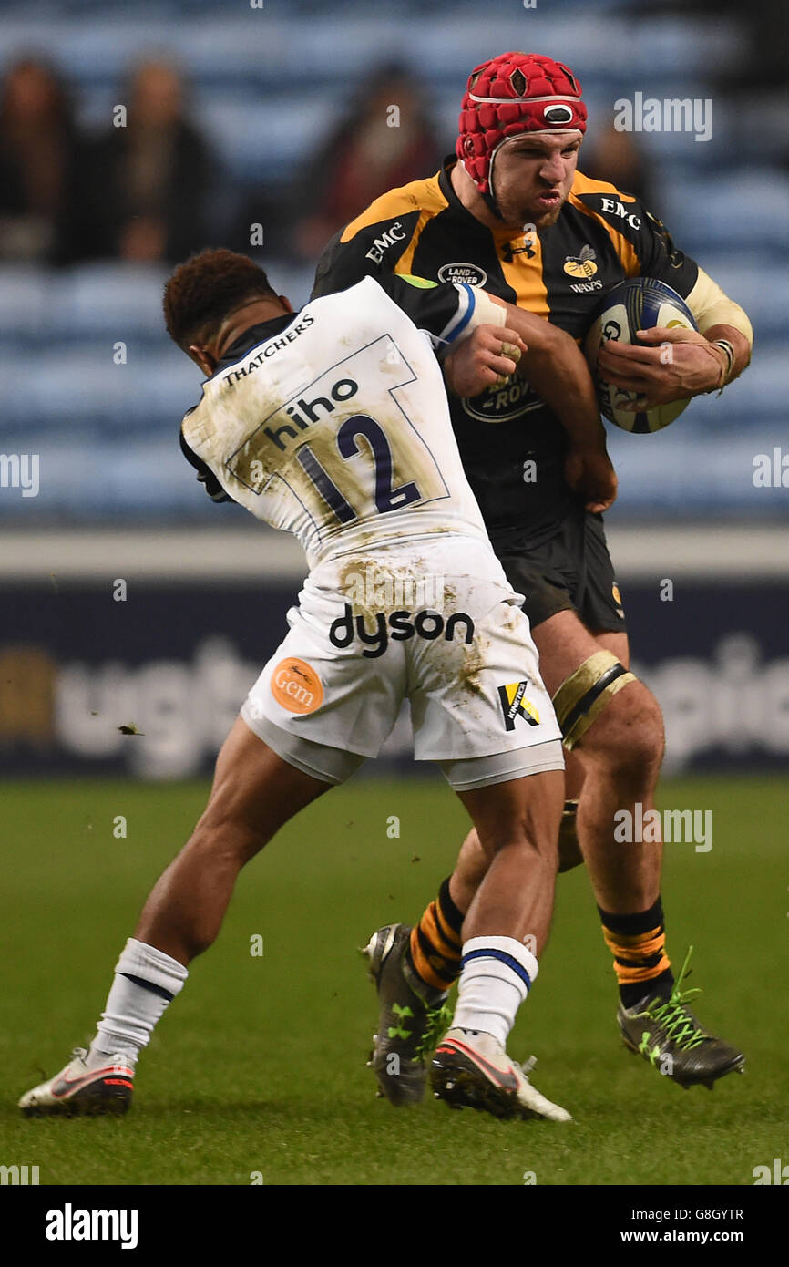 Wasps' James Haskell is tackled by Bath Rugby's Kyle Eastmond (left ...