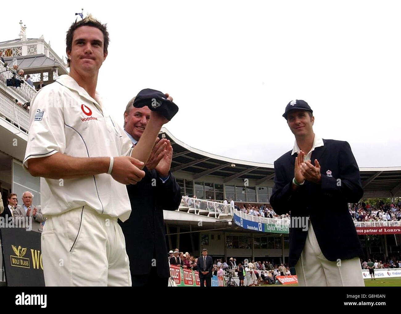 England's Kevin Pietersen (L) receives his first cap from captain ...