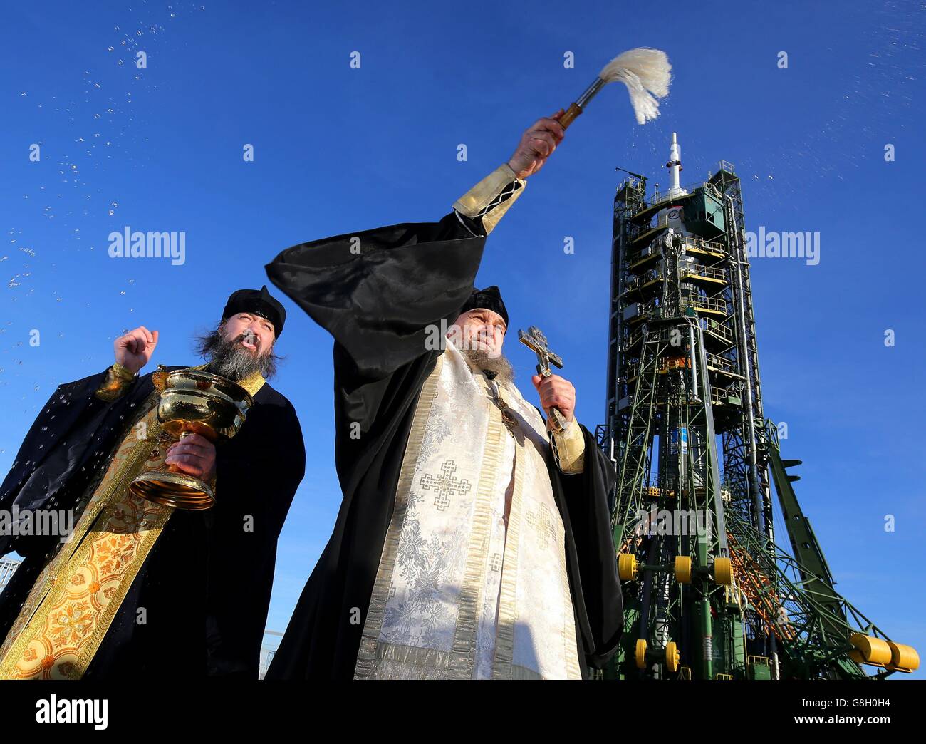 A Russian Orthodox priest blesses the media and well-wishers after a ...