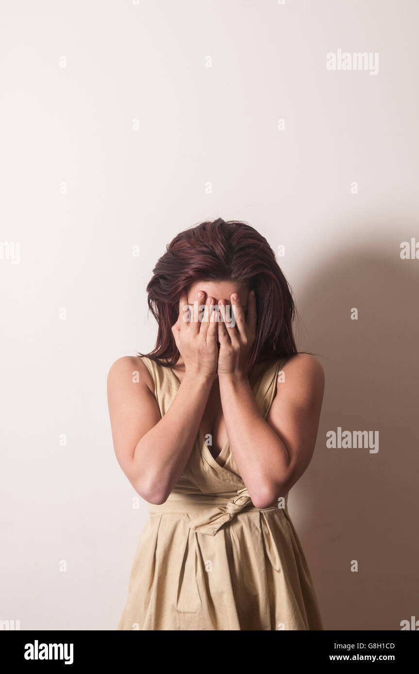 Woman hiding face with hands crying Stock Photo - Alamy