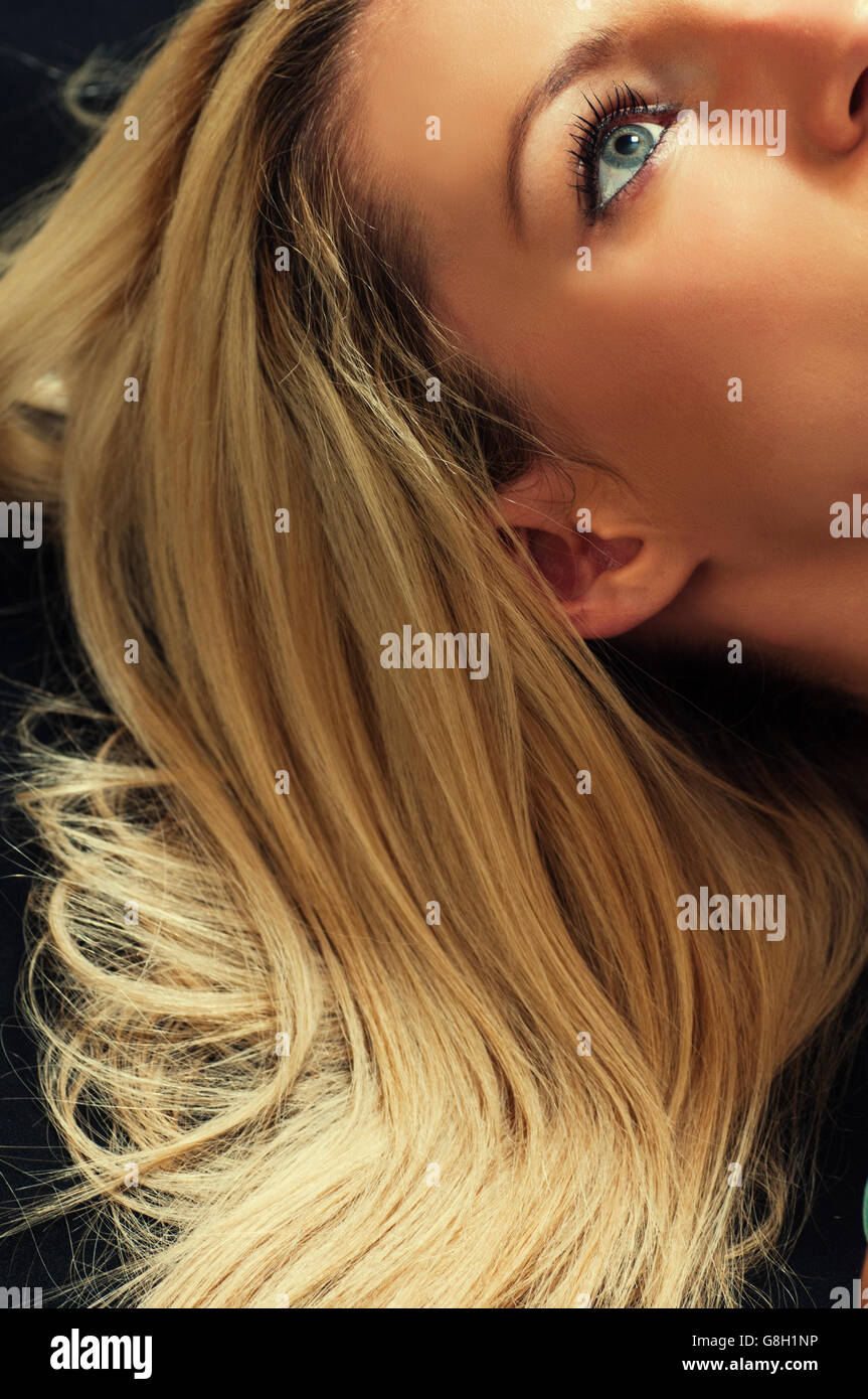 Blond woman laying down looking up Stock Photo - Alamy