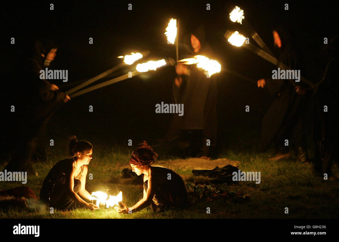Fire dancers prepare to torch a giant Wicker Man, about 35 feet in ...
