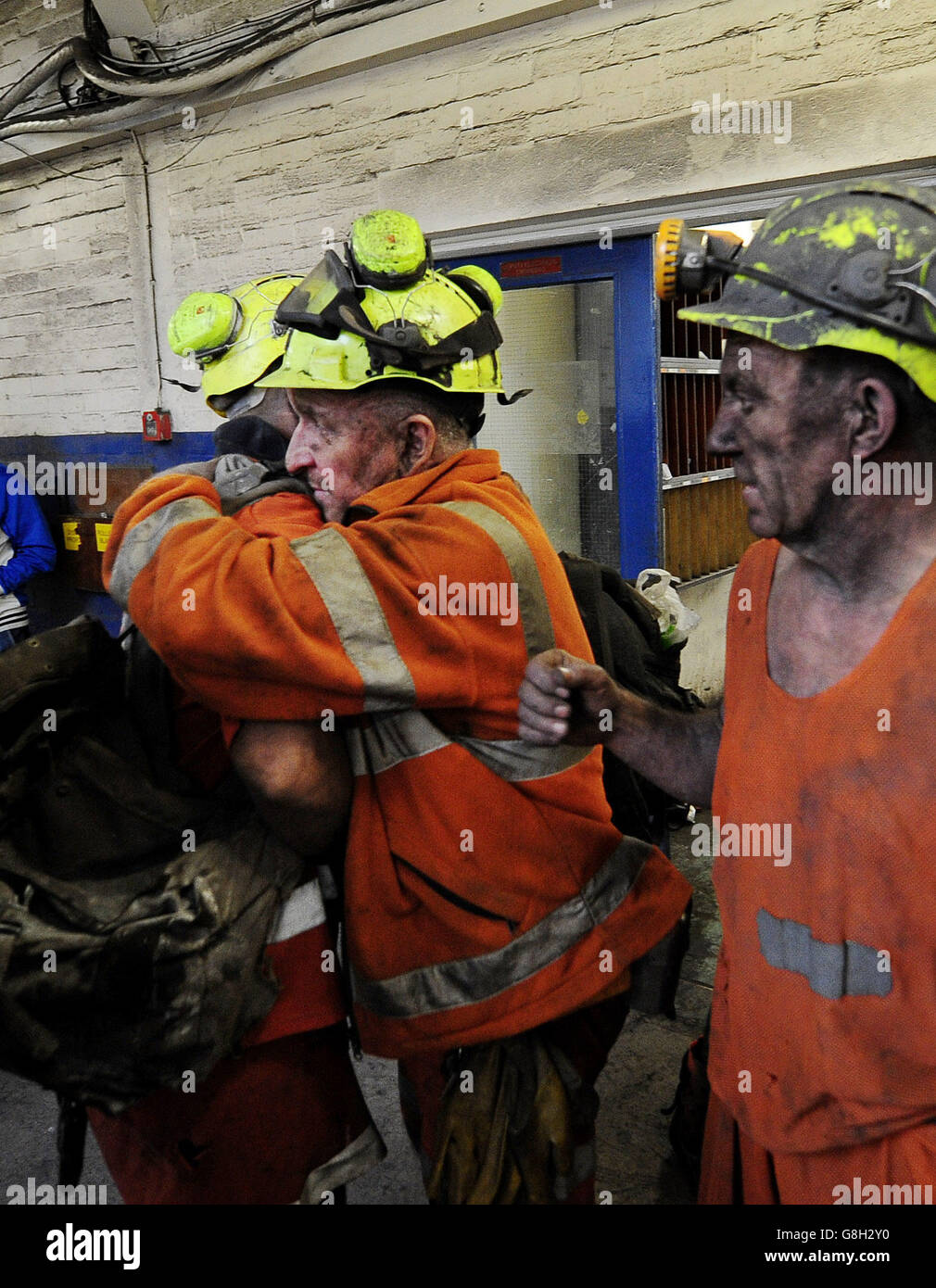 Miners embrace as they come off the last shift at Kellingley Colliery ...