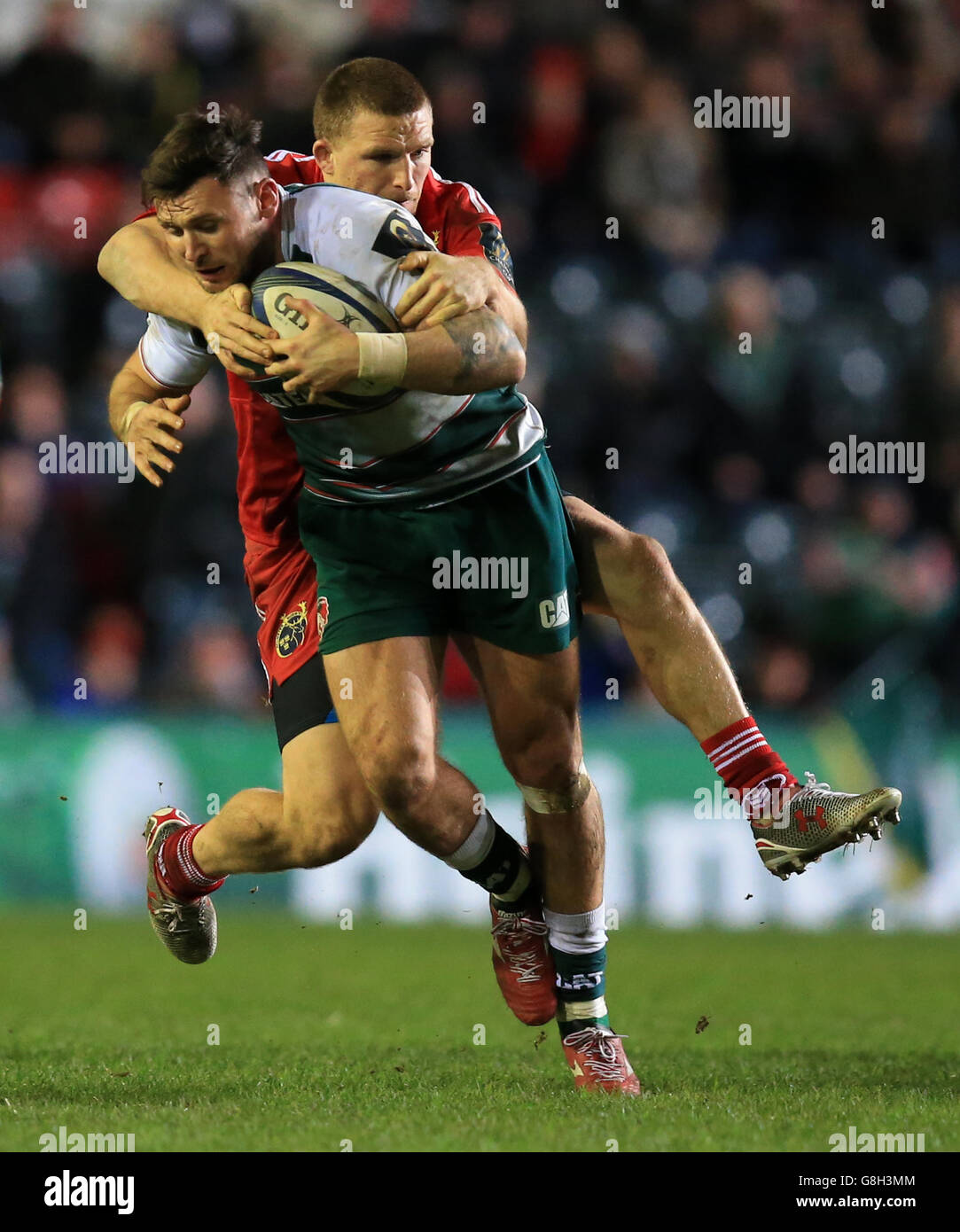 Leicester Tigers' Adam Thompstone and Munster's Andrew Conway during ...