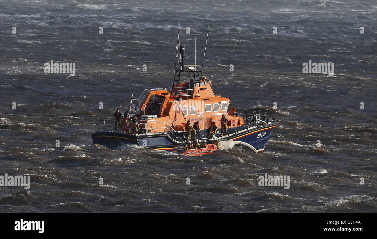A Tynemouth RNLI Lifeboat recovers a small boat in the mouth of the ...