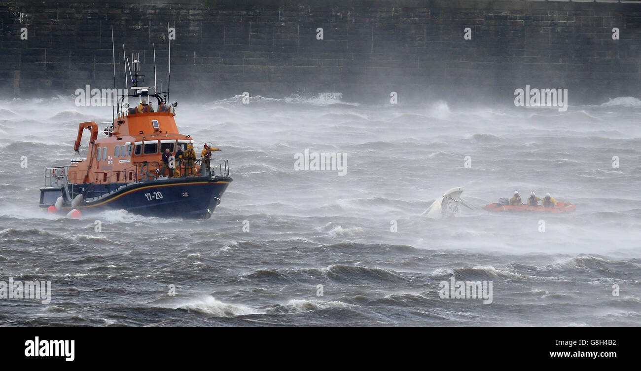A Tynemouth RNLI Lifeboat recovers a small boat in the mouth of the ...