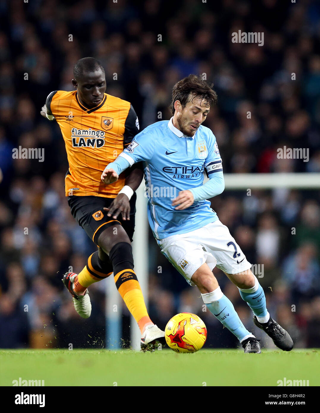 Manchester City's David Silva (right) and Hull City's Mohamed Diame ...