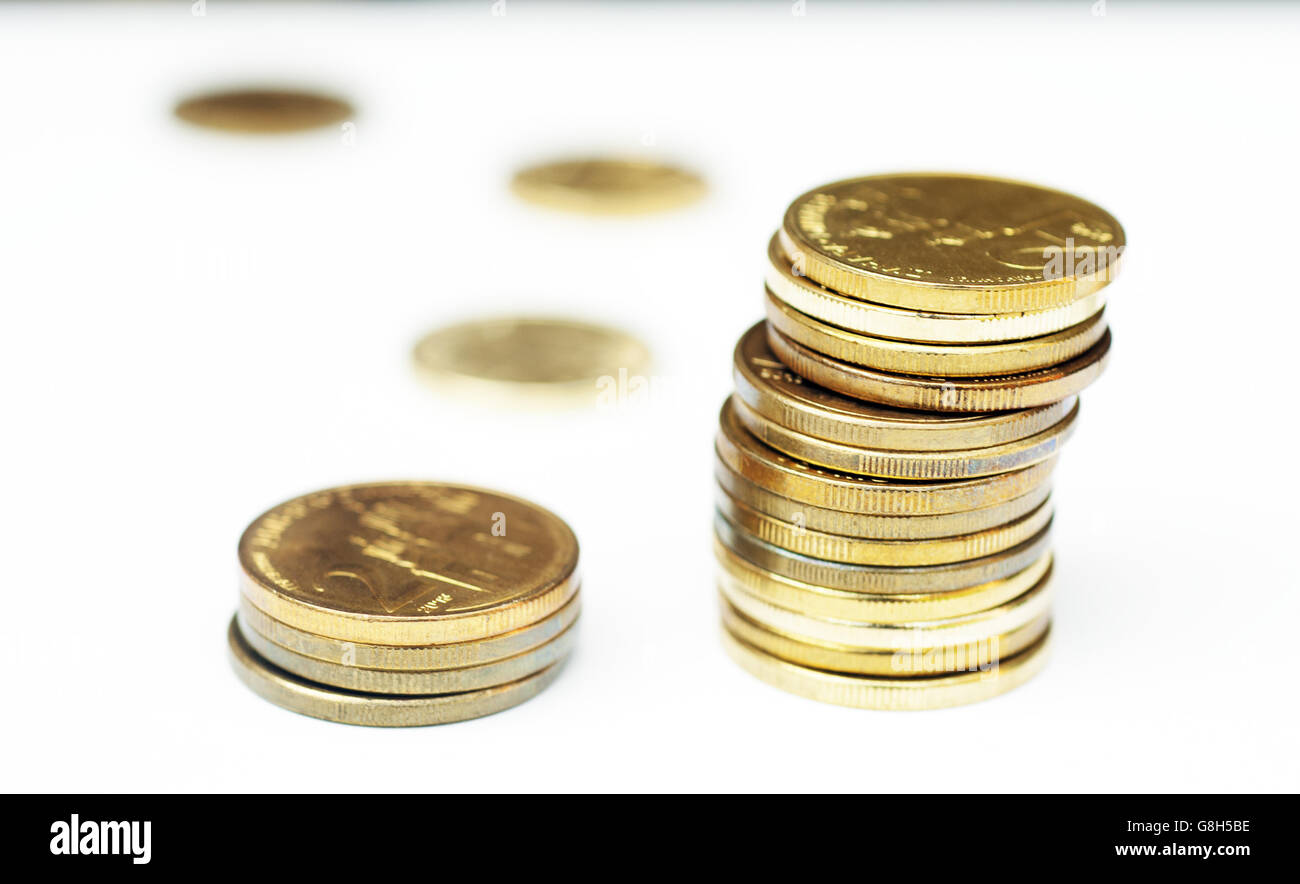 two tower of coins isolated on white Stock Photo - Alamy