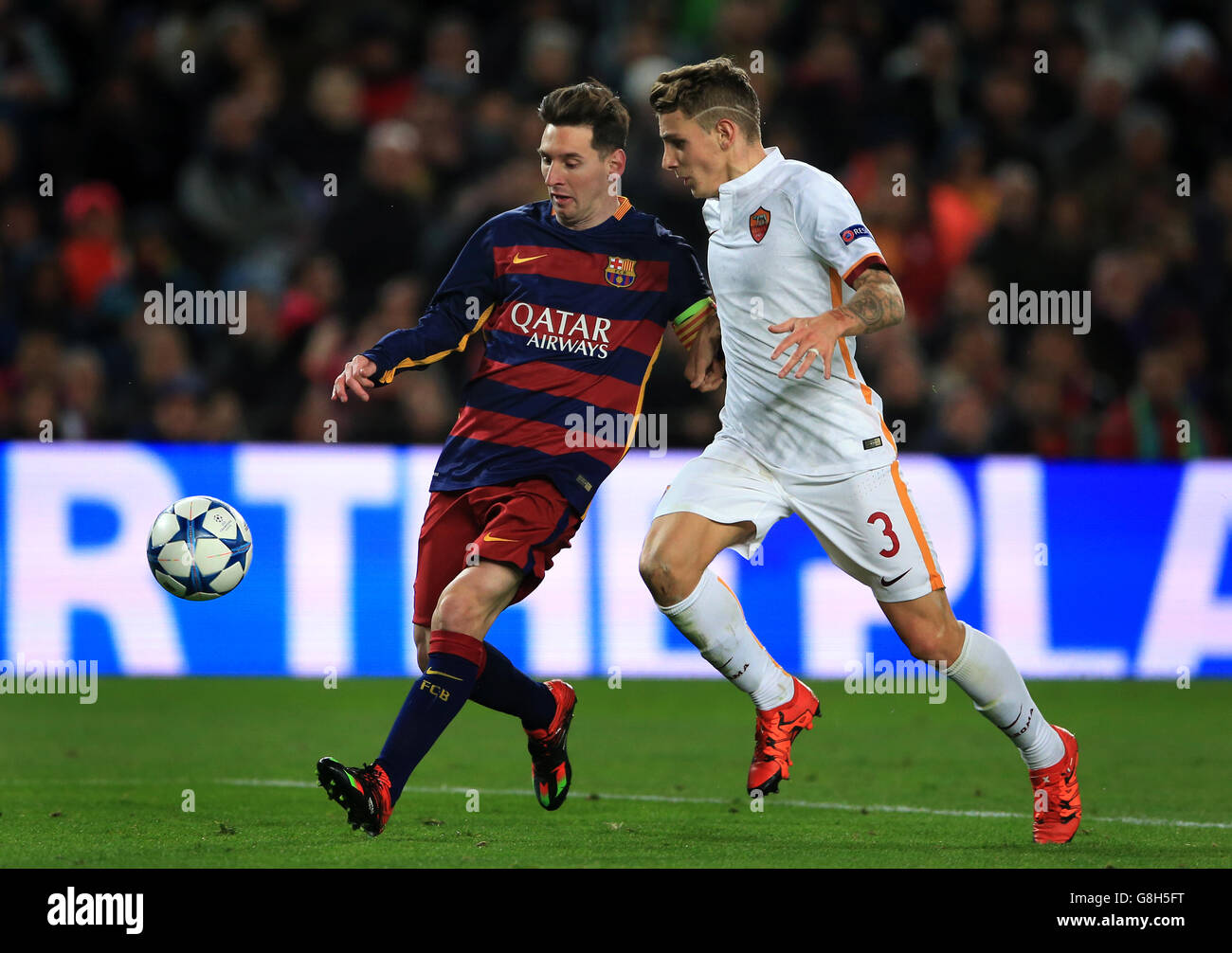 Barcelonas lionel messi and romas lucas digne hi-res stock photography ...
