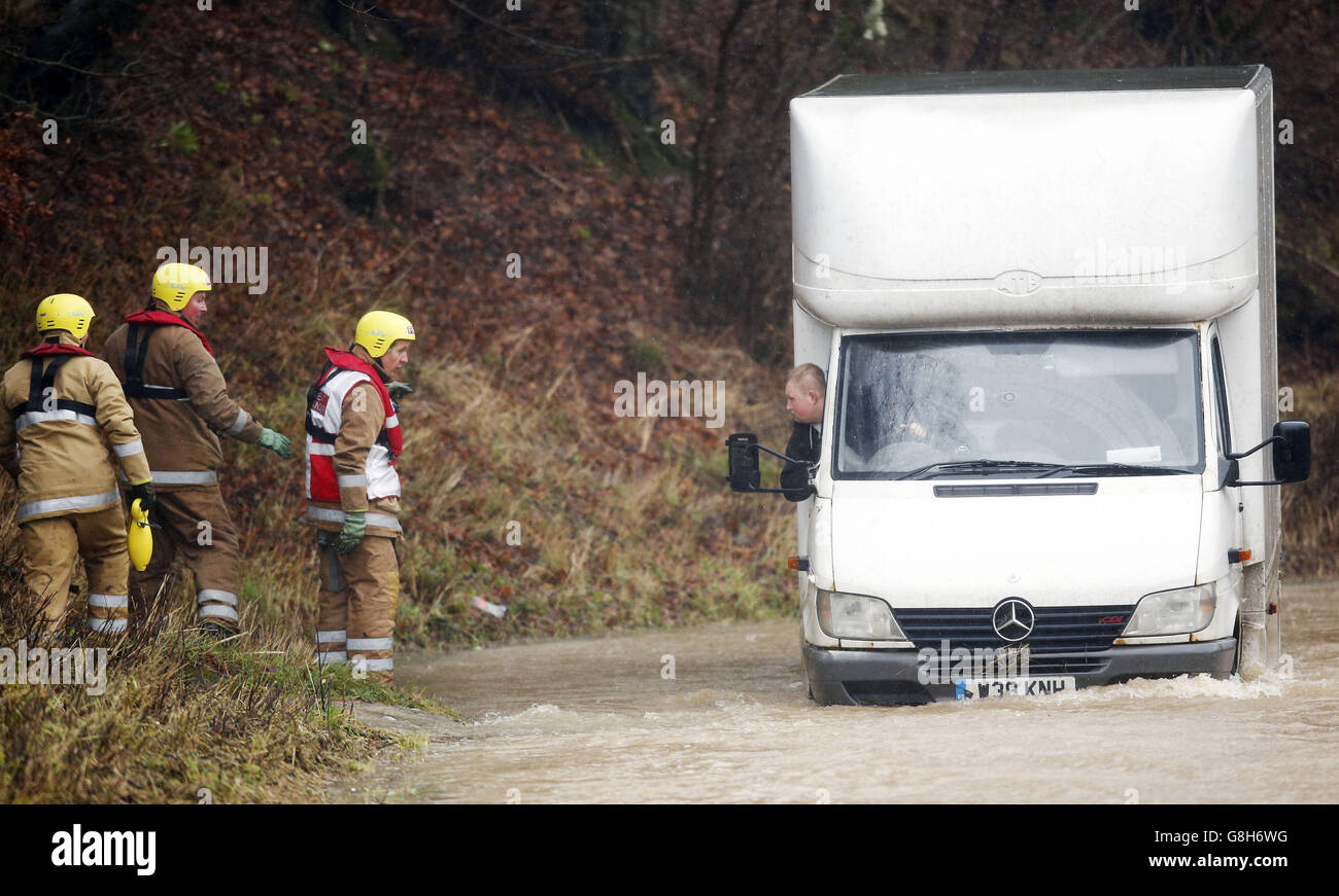A man is helped out of his van after the River Teviot in Hawick ...