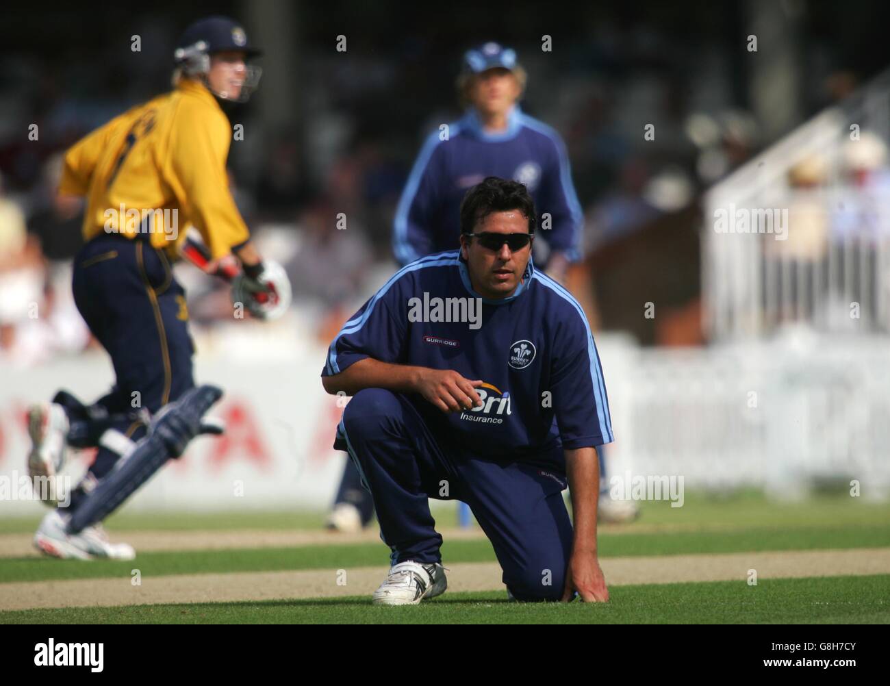 Surrey's Jimmy Ormond can only watch the ball go to the boundary as ...