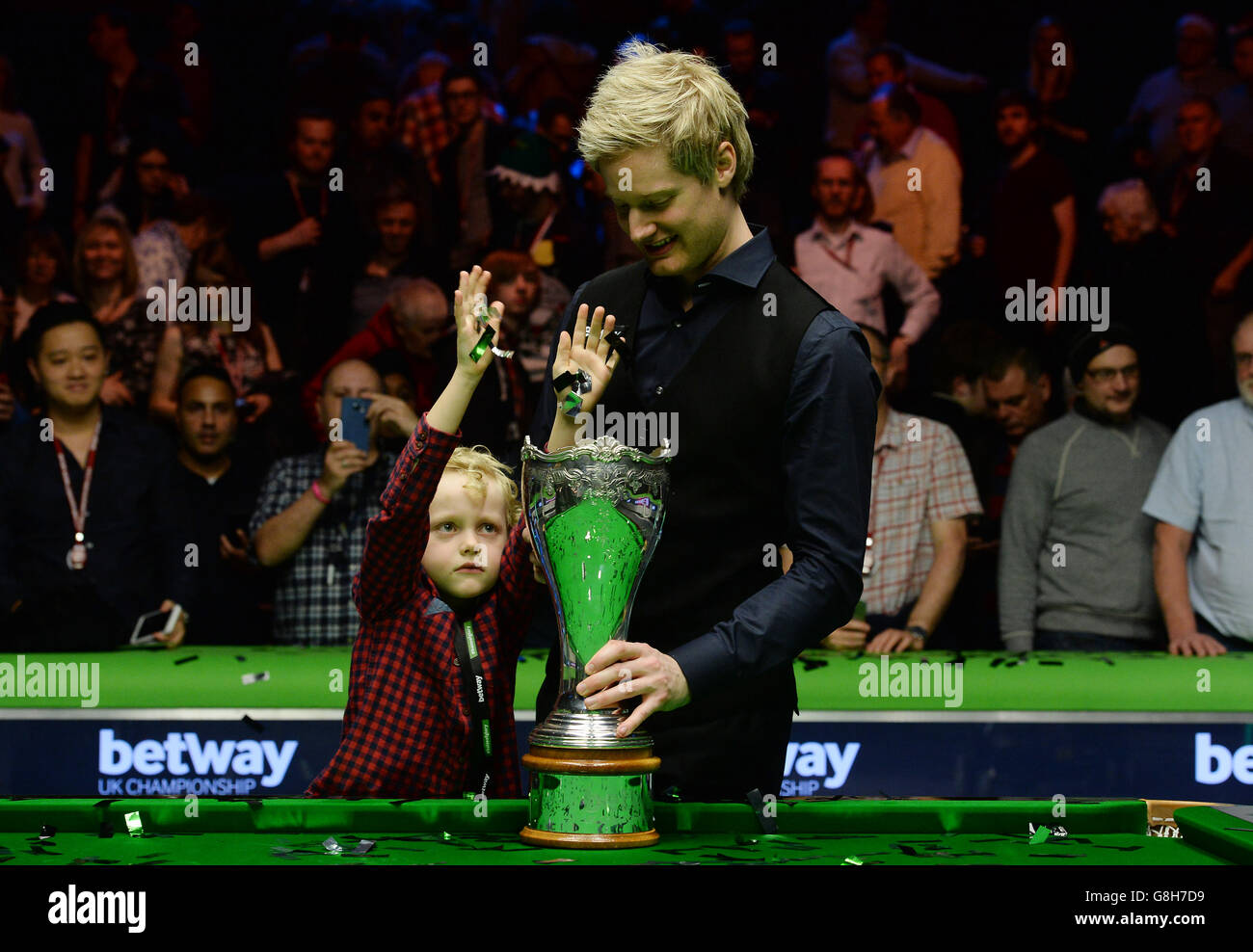 Neil Robertson celebrates with the trophy and his son Alexander after ...