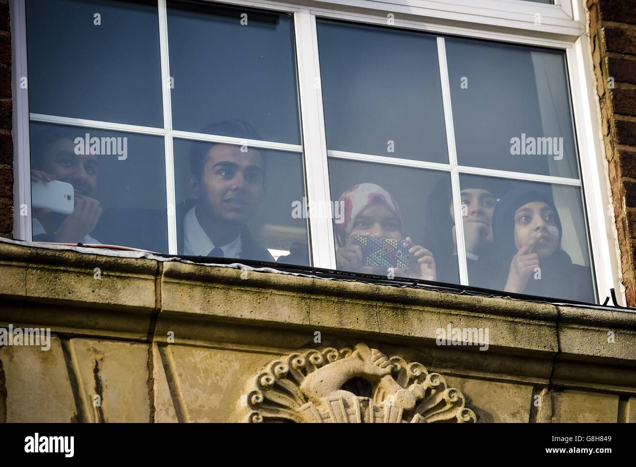 Pupils watch from a window as the Duke of Cambridge visits Saltley ...