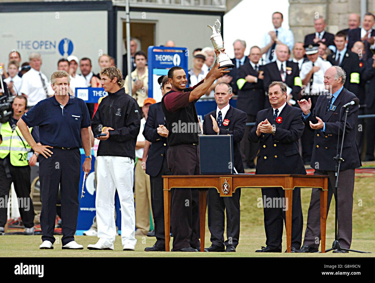 Tiger Woods lifts the trophy after winning the 134th Open Championship ...