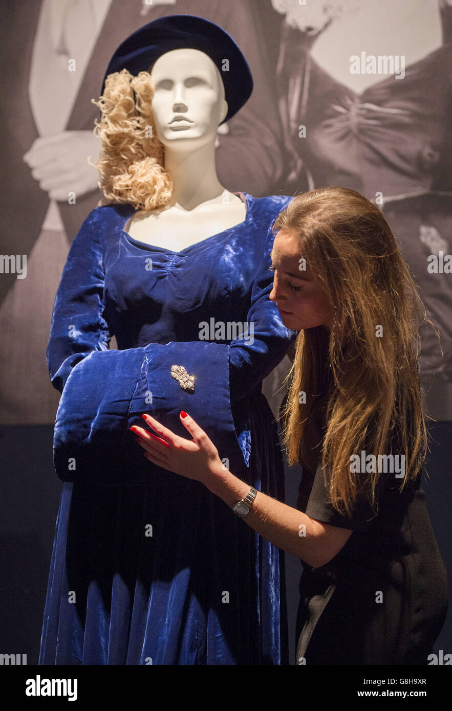 Christies staff member adjusts margaret thatchers wedding outfit ...