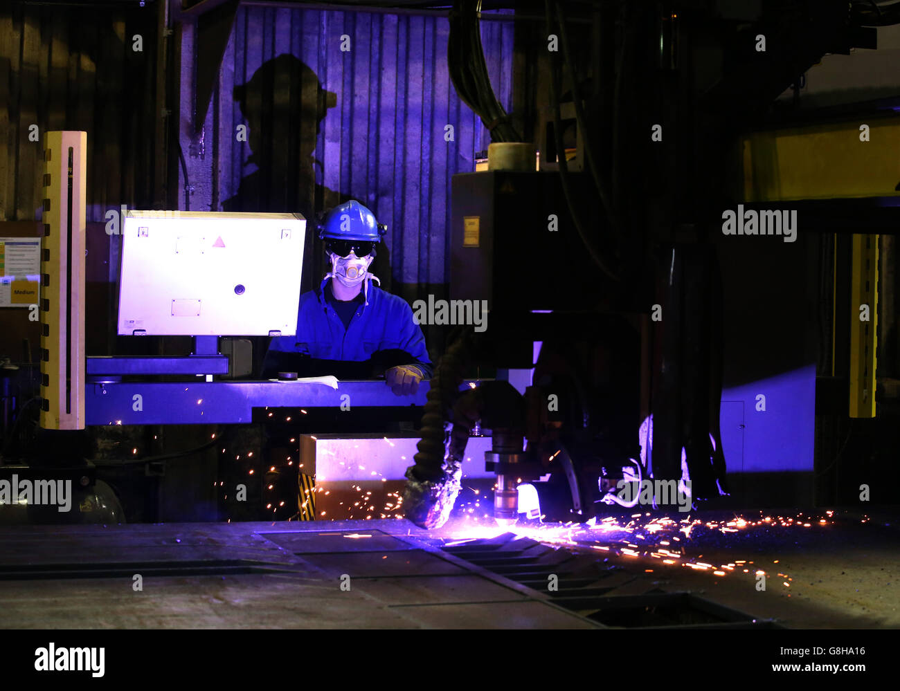 A burner uses a plasma cutter to cut steel plates at Watson Towers in ...