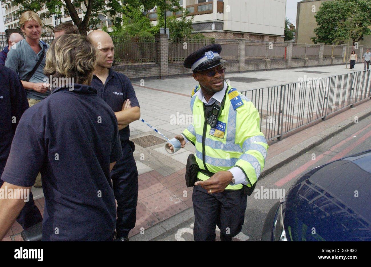 A police community support officer helps to evacuate people outside the ...
