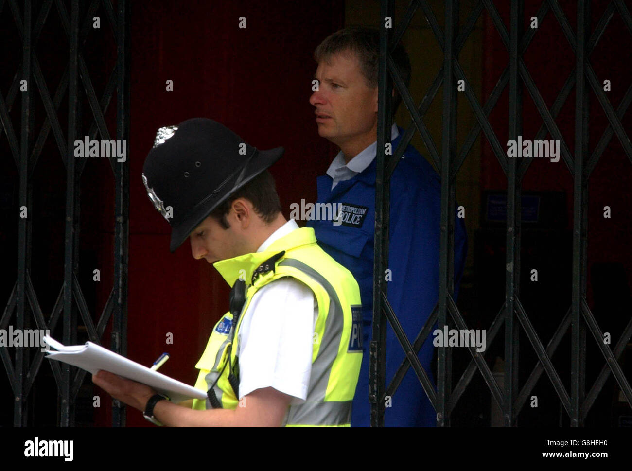 A member of the Police's SO13 team appears at the gates of Warren ...