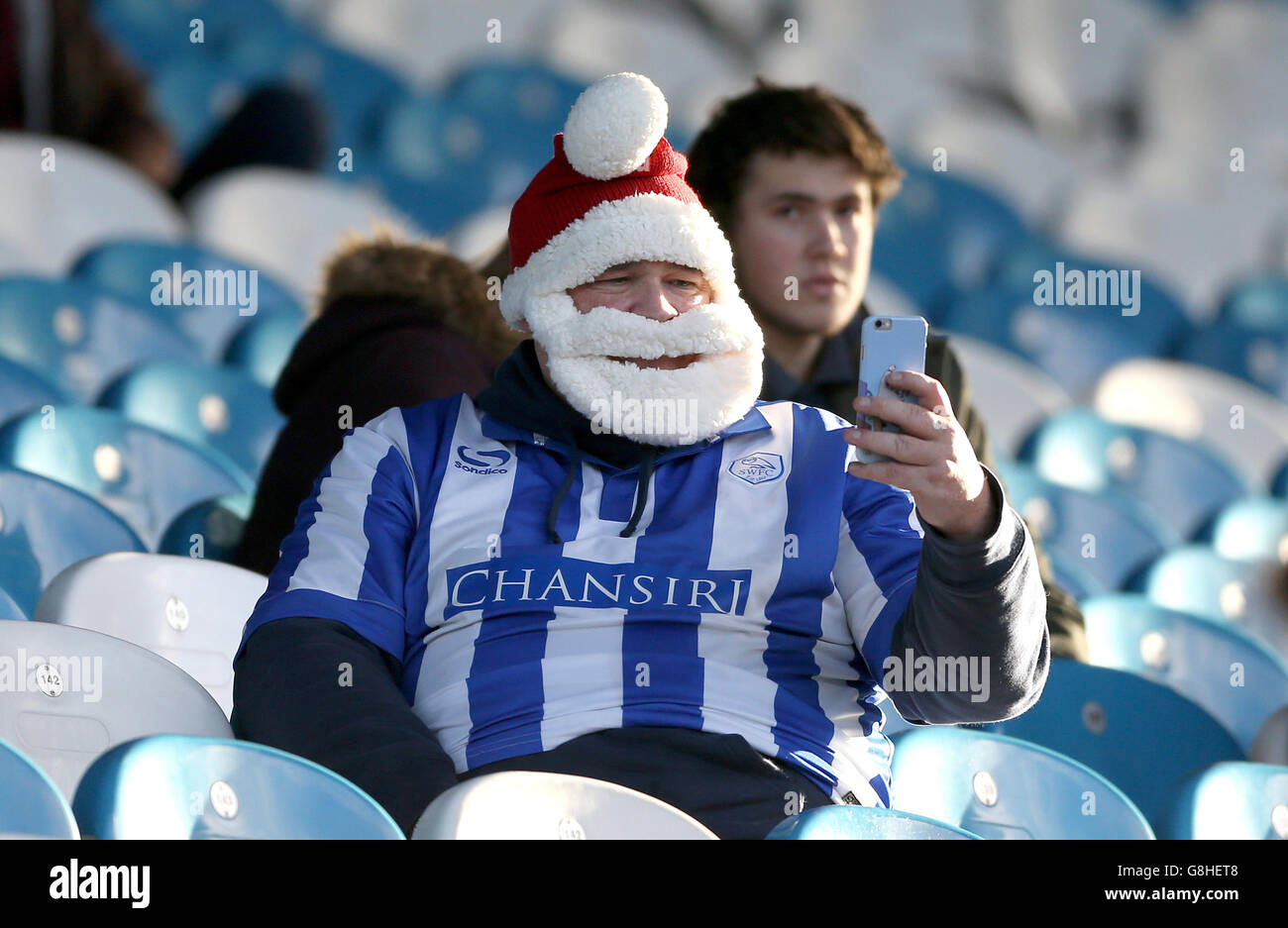 A Sheffield Wednesday fan wears a Santa Claus mask in the stands during ...