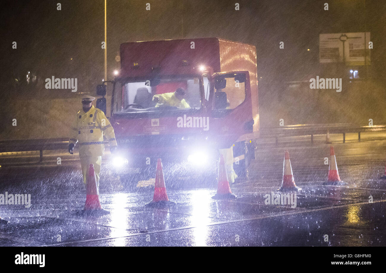 Police check the weight of a lorry before allowing it to cross the ...