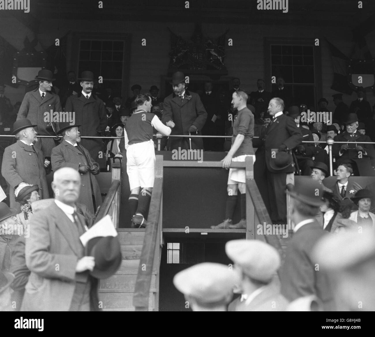 King George V shakes hands with one of the players after the FA Cup ...