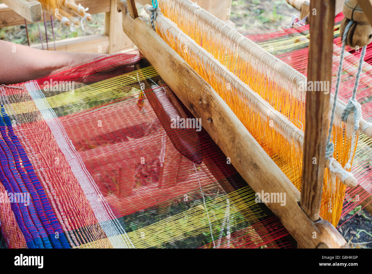 Weaving on a wooden loom Stock Photo - Alamy