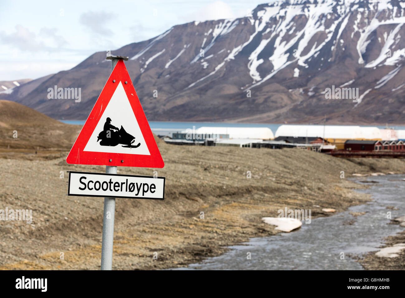 Snowmobile traffic warning sign with Longyearbyen River and ...