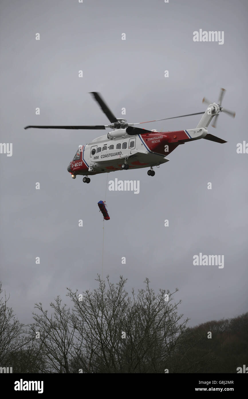 A coastguard rescue helicopter winches a stretcher over Hebden Bridge ...
