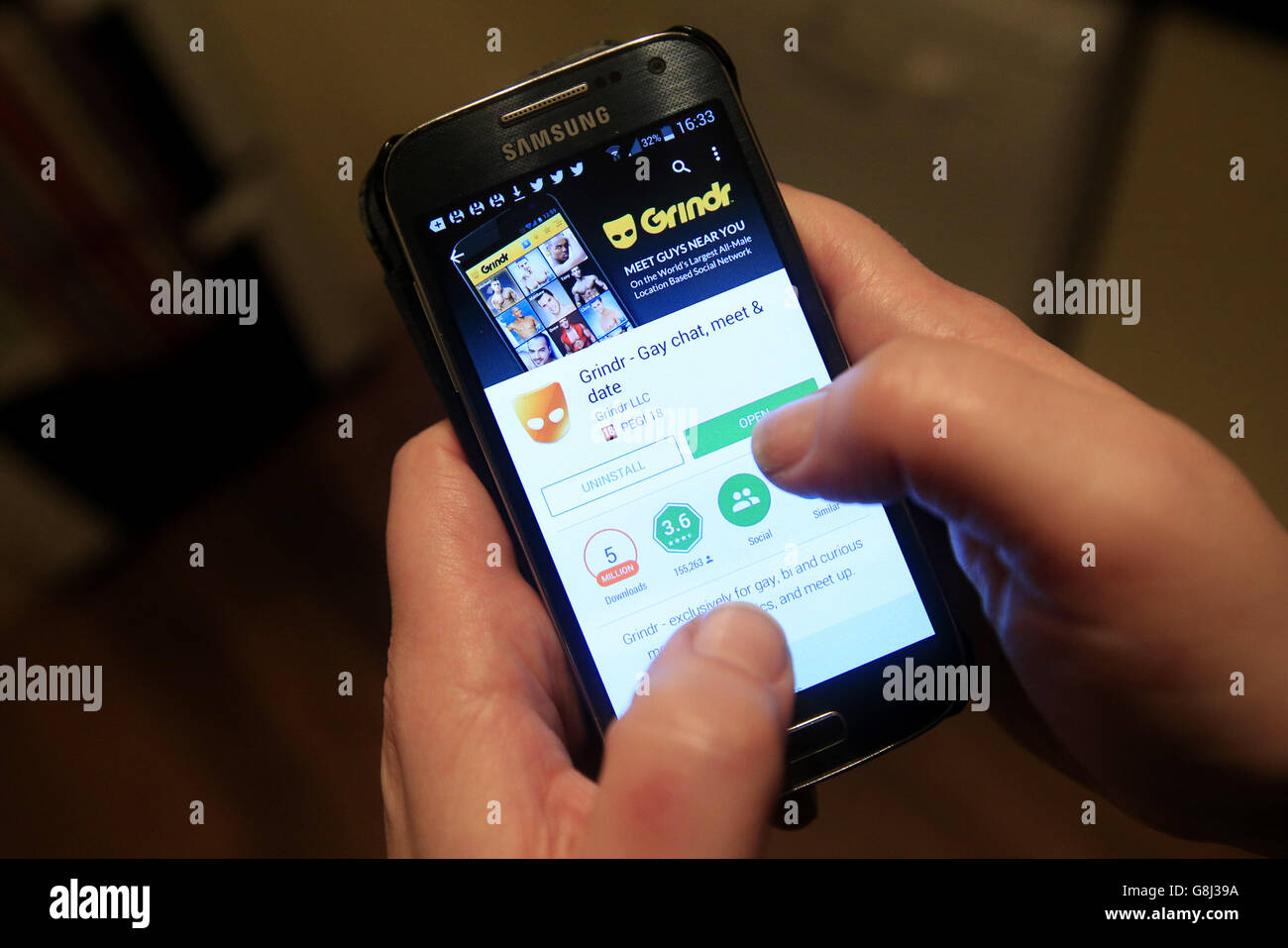 The grindr app in use on a samsung smartphone hi-res stock photography ...
